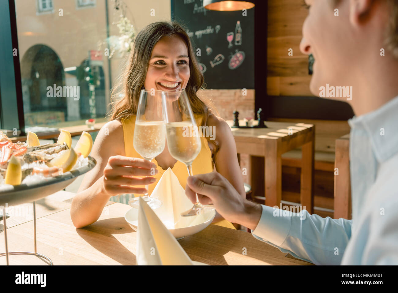 Beautiful woman toasting during a romantic dinner with her partner ...