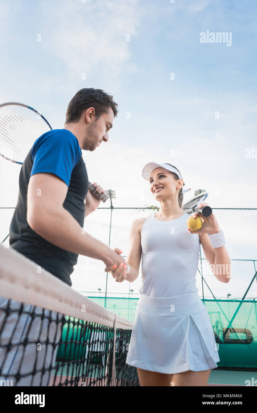 Tennis player man and woman giving handshake after match Stock Photo ...