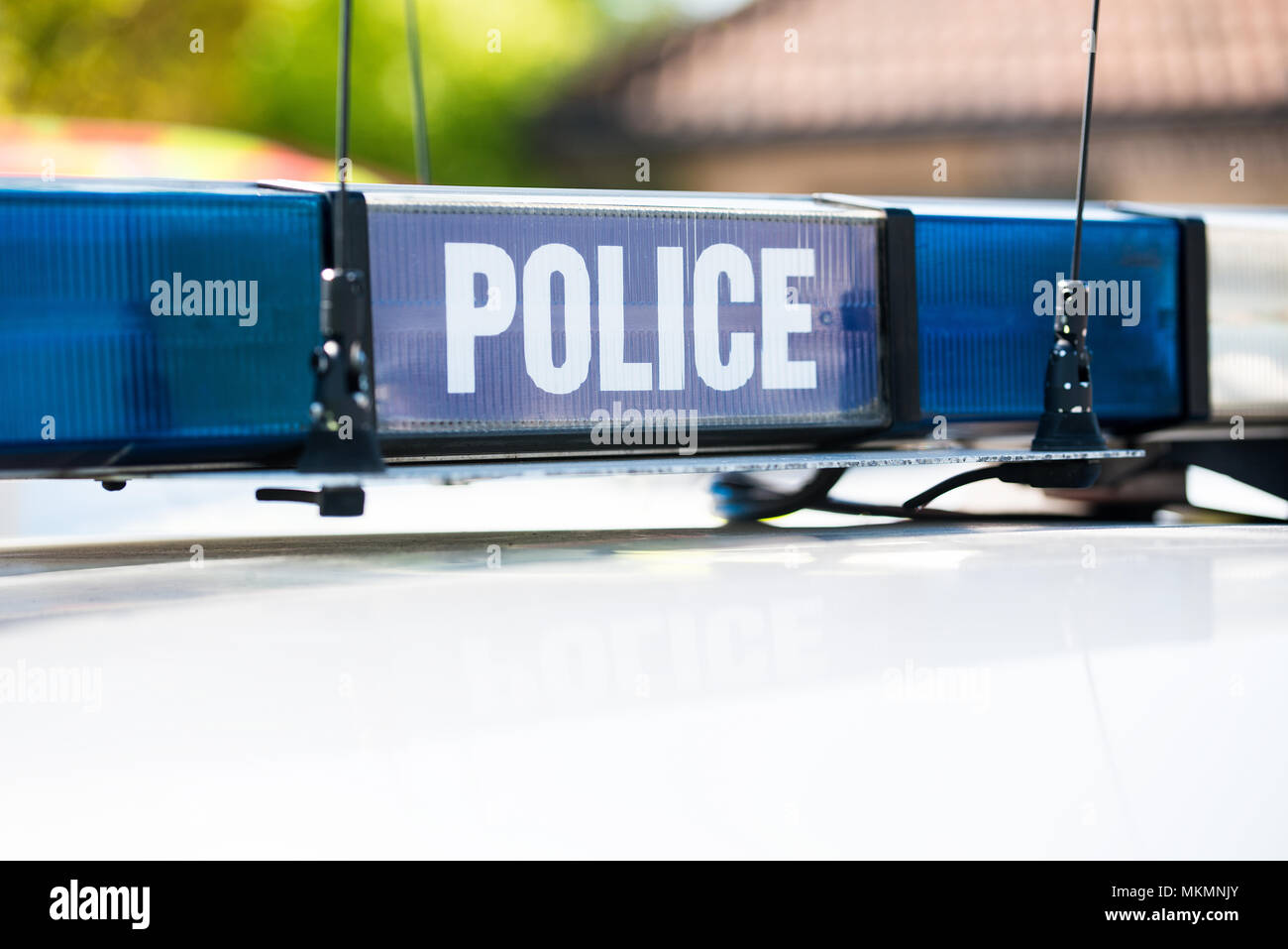 Police sign with blue lights on top of a patrol vehicle Stock Photo - Alamy