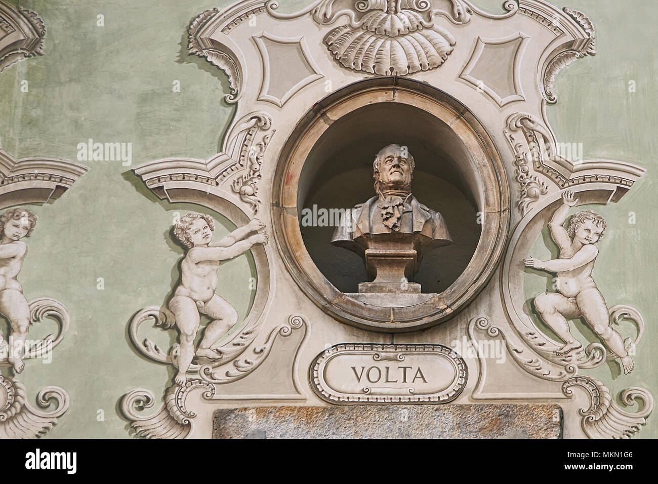 Vintage sculpture portrait of Alessandro Volta on a facade of an old ...