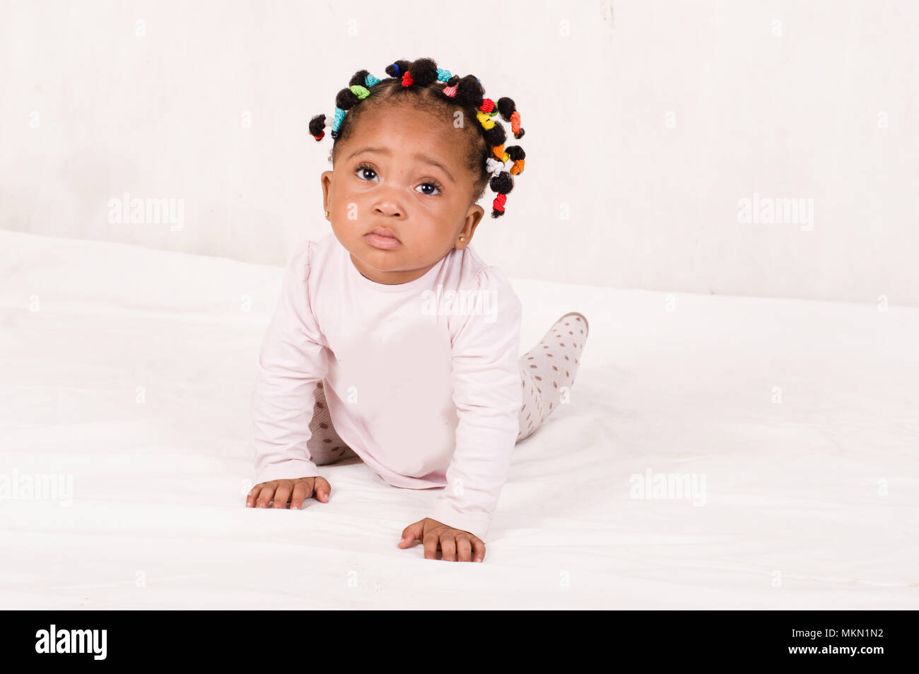 Pretty baby creeping looking up isolated on white background Stock ...