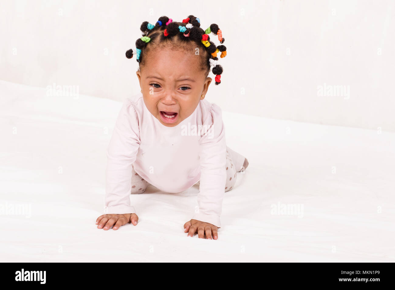 Photo of baby crawling towards his mother crying isolated on white ...
