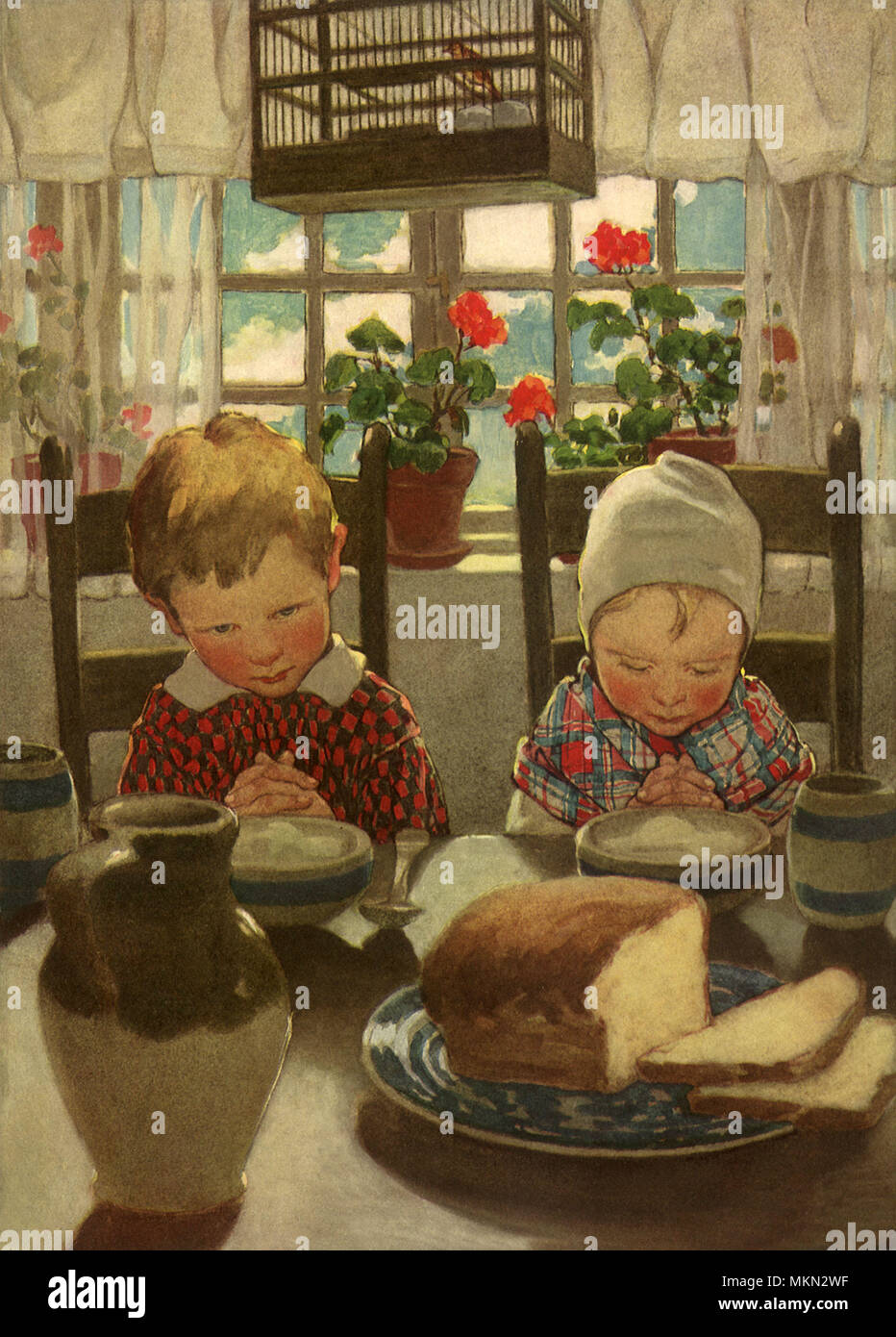 Boy, Girl Praying with Bread at the Table Stock Photo - Alamy