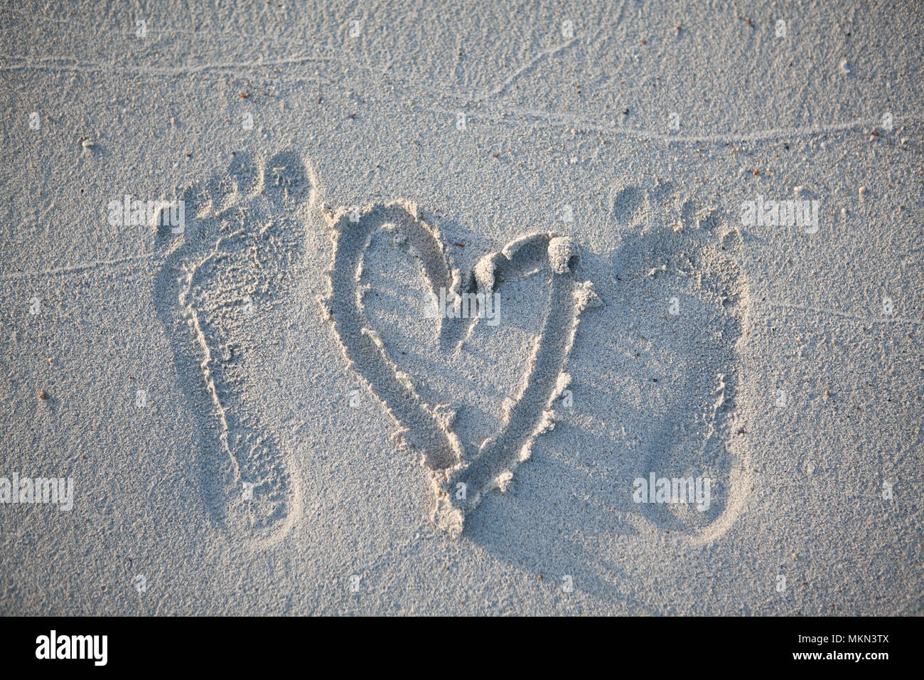 Footprints of the groom and the bride's feet and a painted heart on the ...