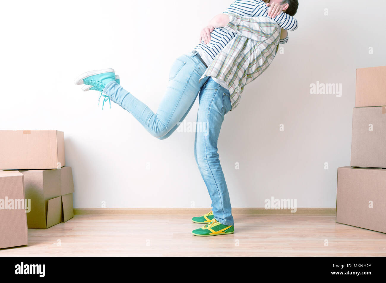 Image of hugging men and women among cardboard boxes Stock Photo - Alamy