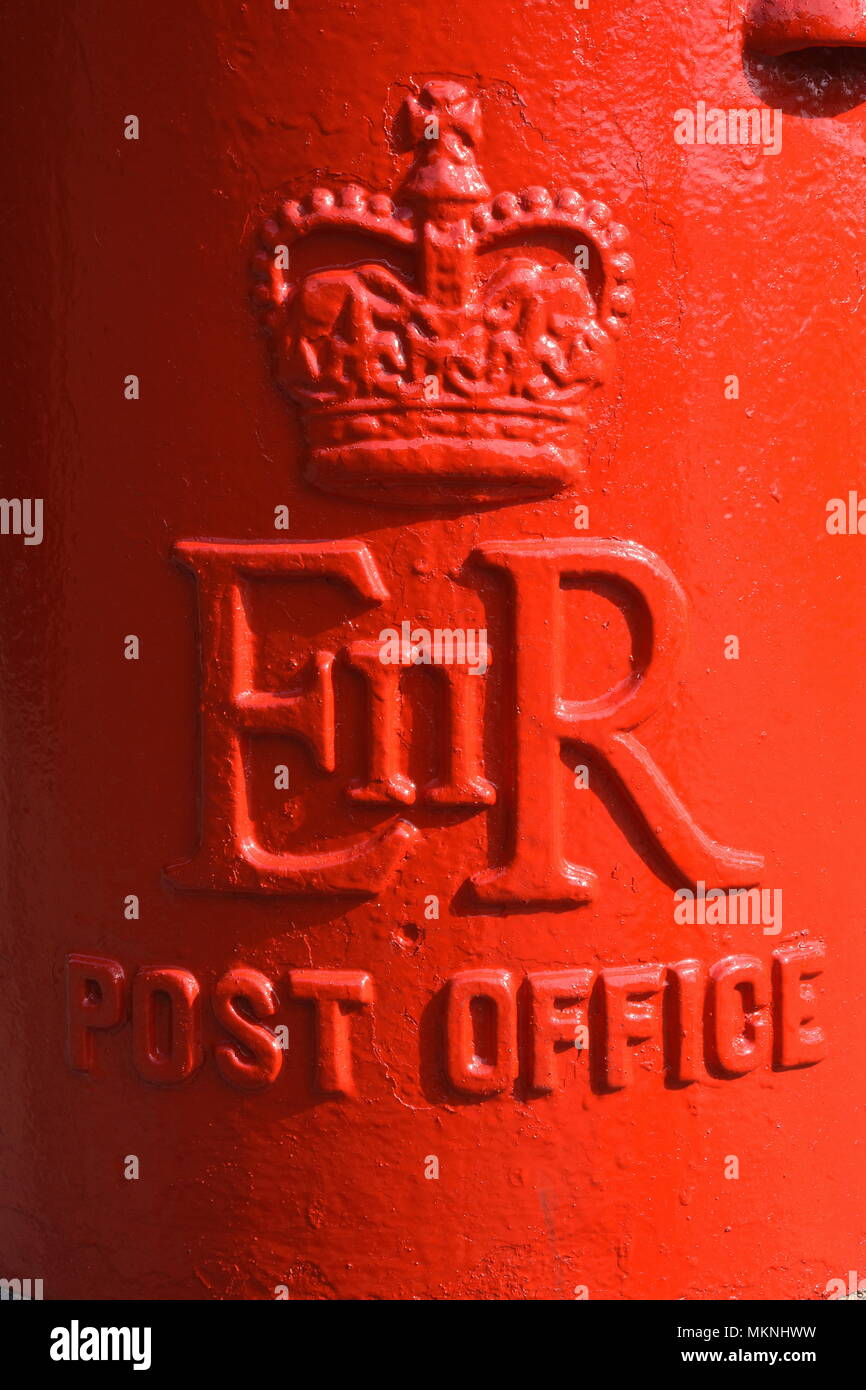 Detail of freshly painted red letter box with ER post office emblem ...