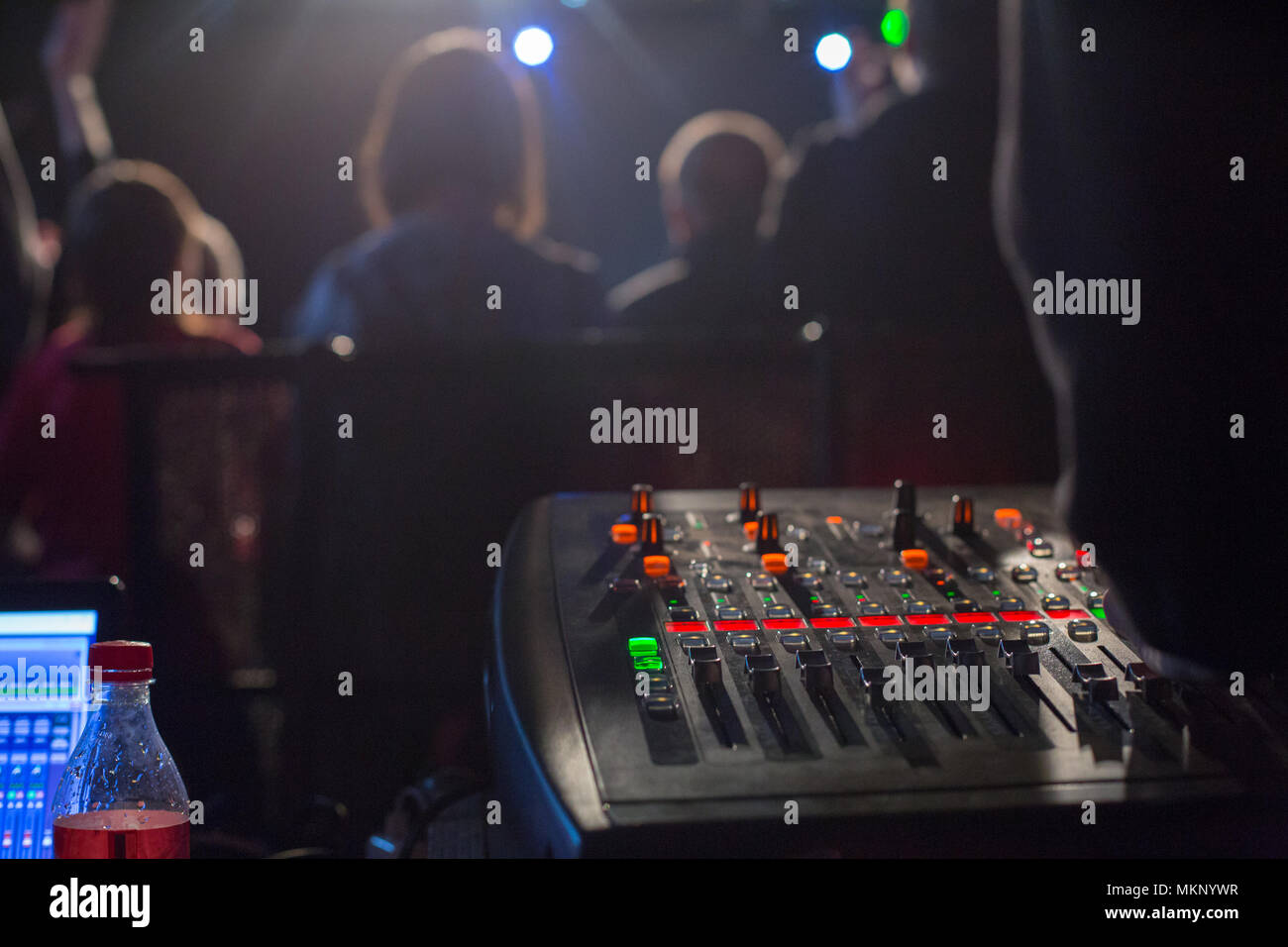 Soundman working on the mixing console in concert hall Stock Photo - Alamy