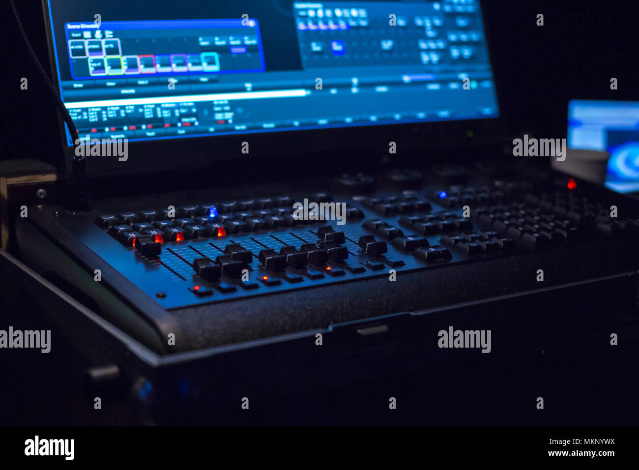 Soundman working on the mixing console in concert hall Stock Photo - Alamy