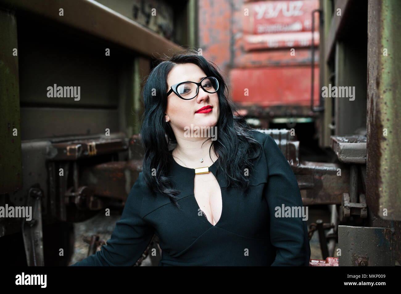 Brunette girl wear in black with glasses in railway station Stock Photo ...