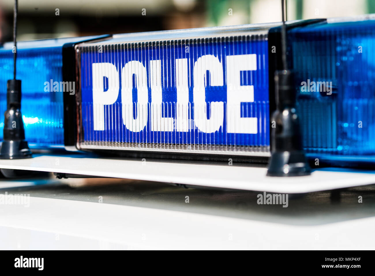 Police sign with blue lights on top of a patrol vehicle Stock Photo - Alamy