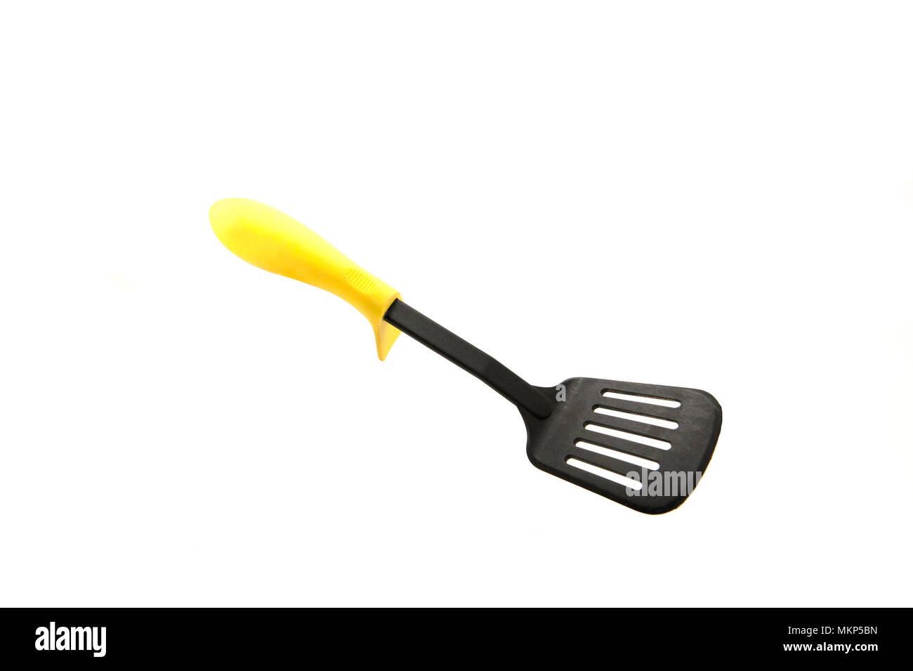 Plastic spade of frying pan with yellow grip isolated on white ...