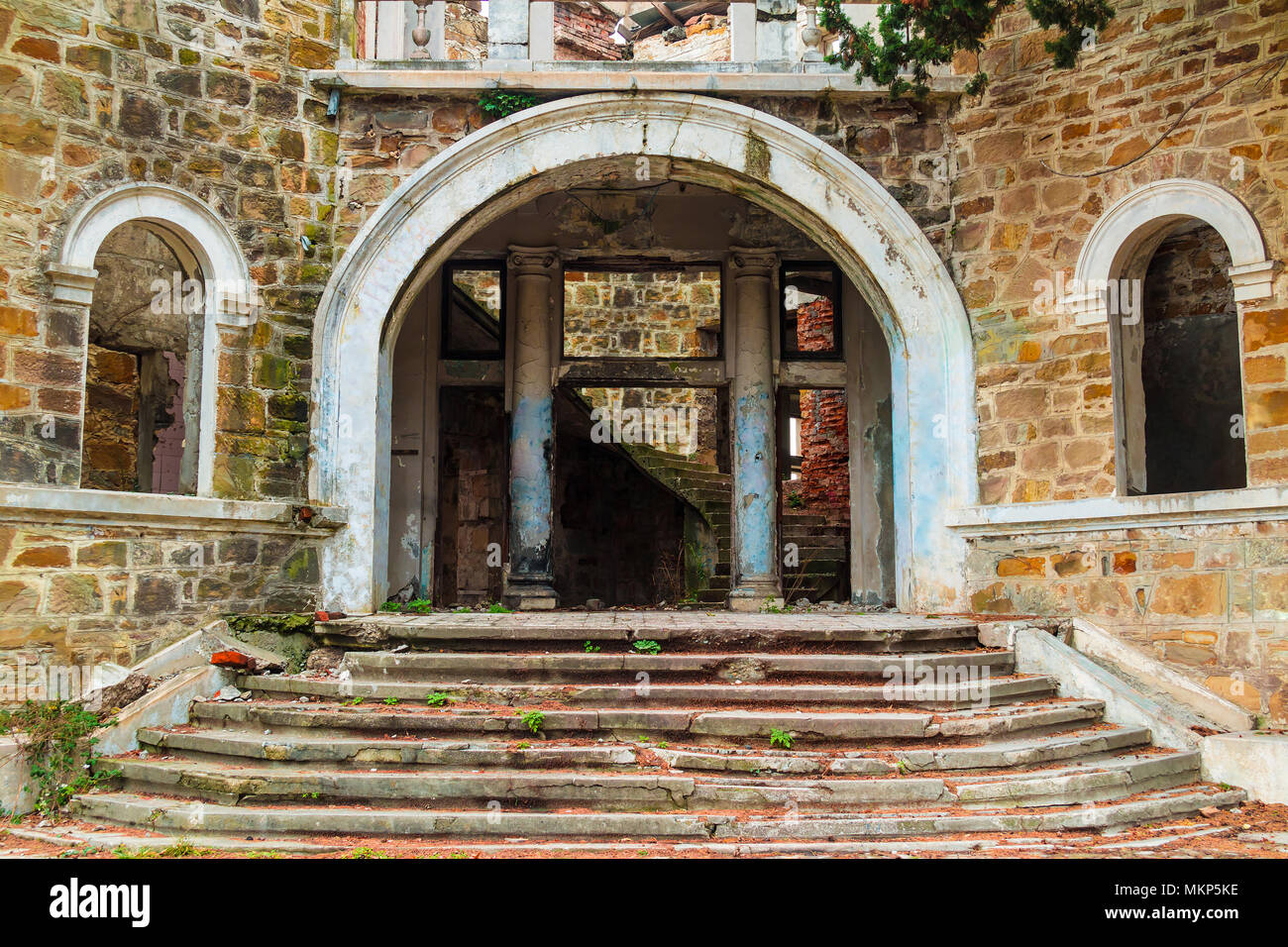 The main entrance with stairs of the abandoned old mansion called Dacha ...