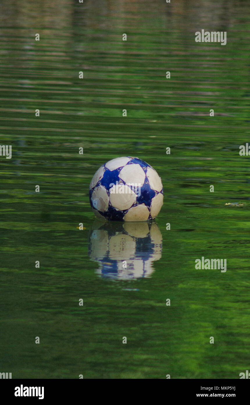 a soccer ball floating in a river water Stock Photo - Alamy