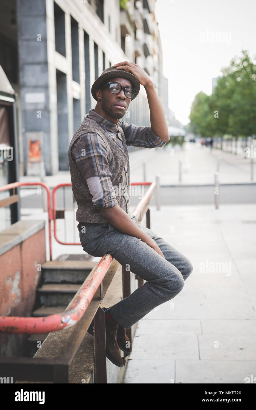 young handsome millennial black man outdoor posing looking away ...