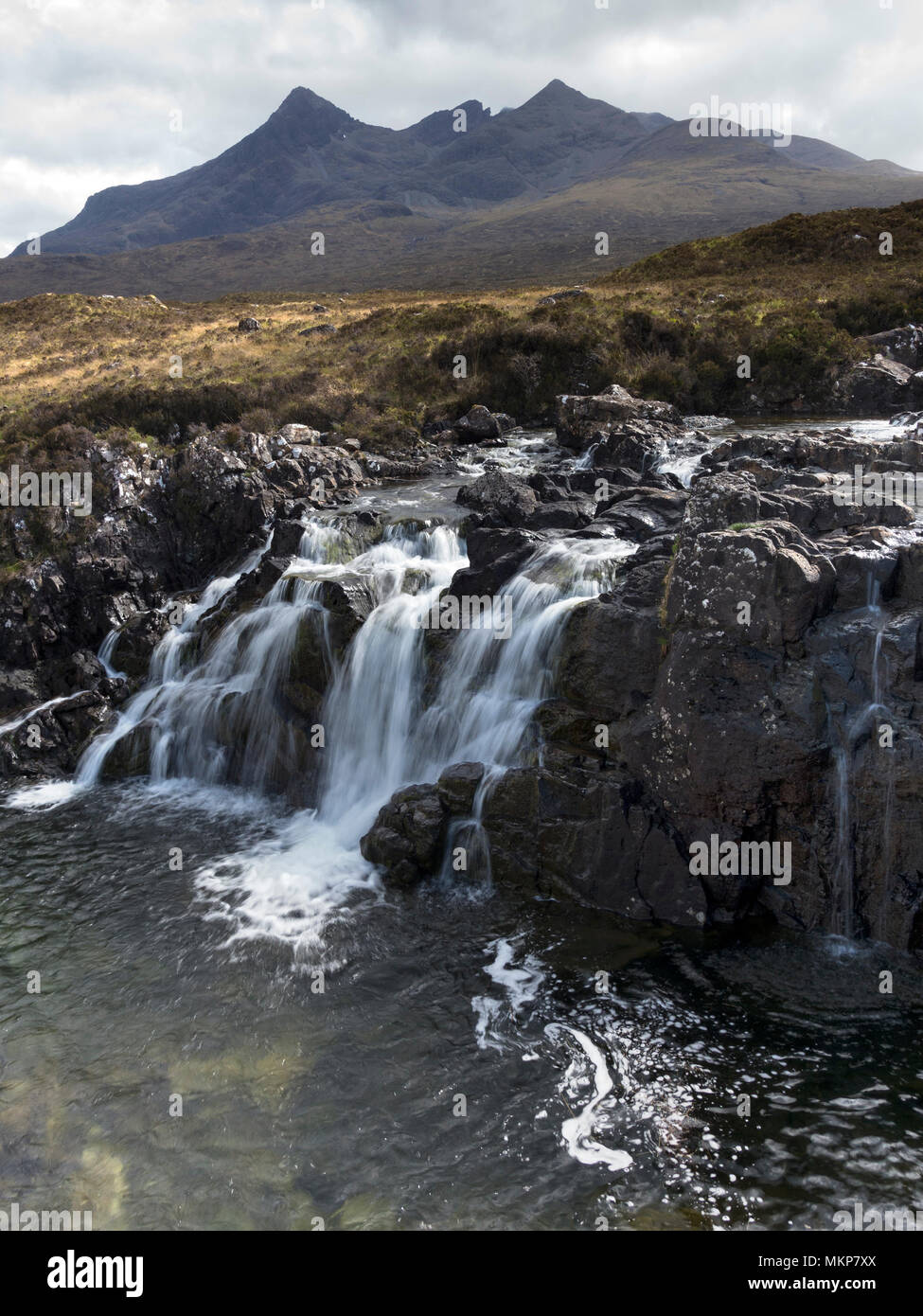 Waterfall in mountain stream of Allt Dearg Mor with Black Cuillin ...