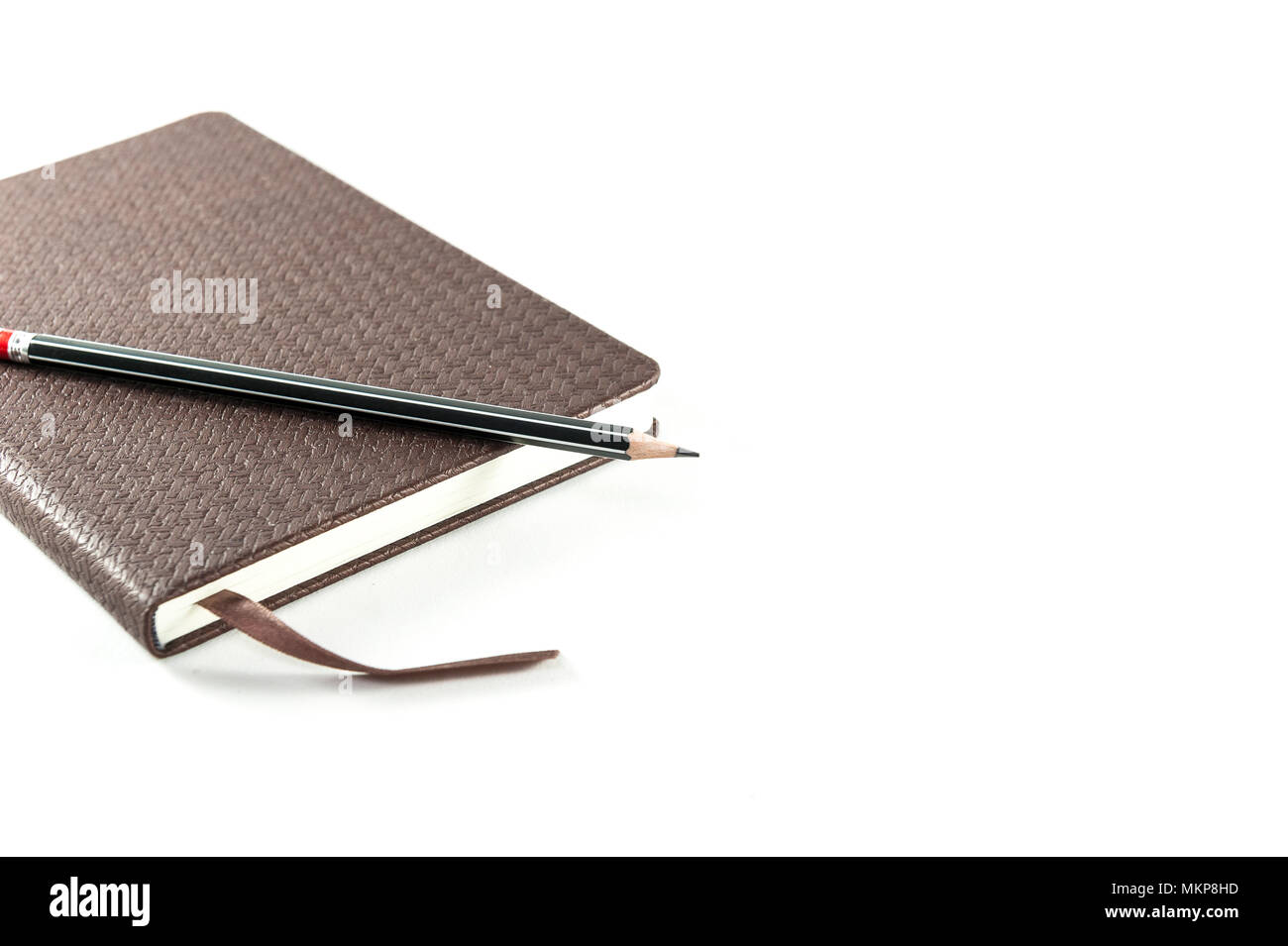 Brown notebook diary with black pencil on white background Stock Photo ...