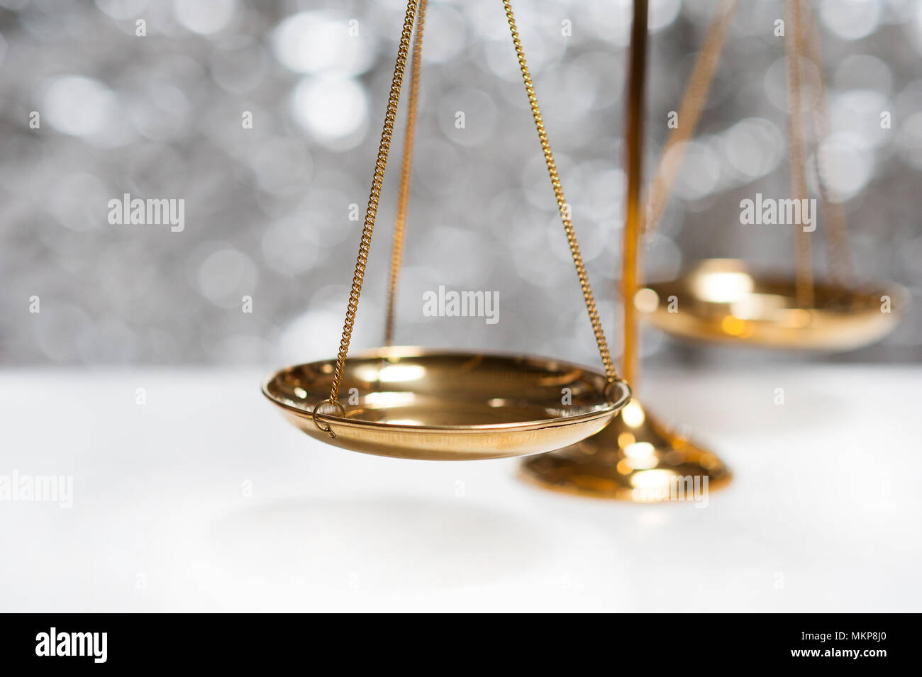 Close up of gold brass balance scale, Sign of justice isolated on bokeh ...
