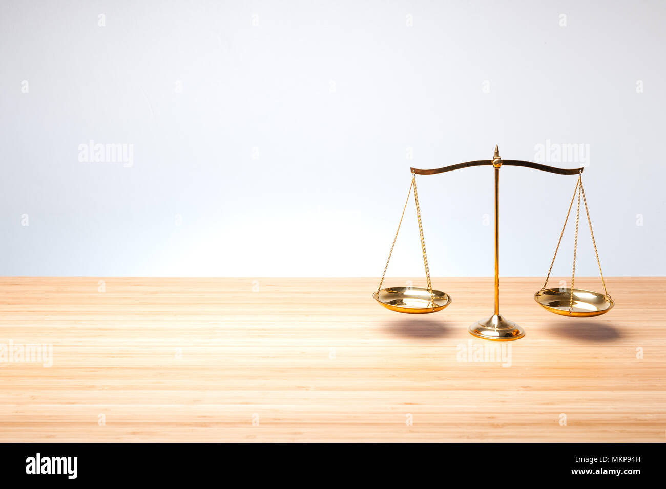 Gold brass balance scale, weight balance scale on wooden desktop with ...