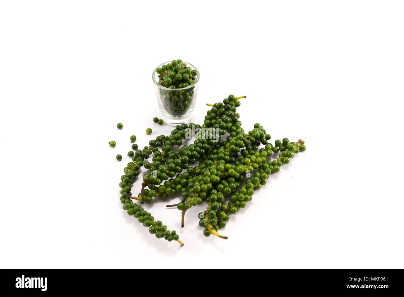 Fresh green pepper corn in glass on white background Stock Photo - Alamy