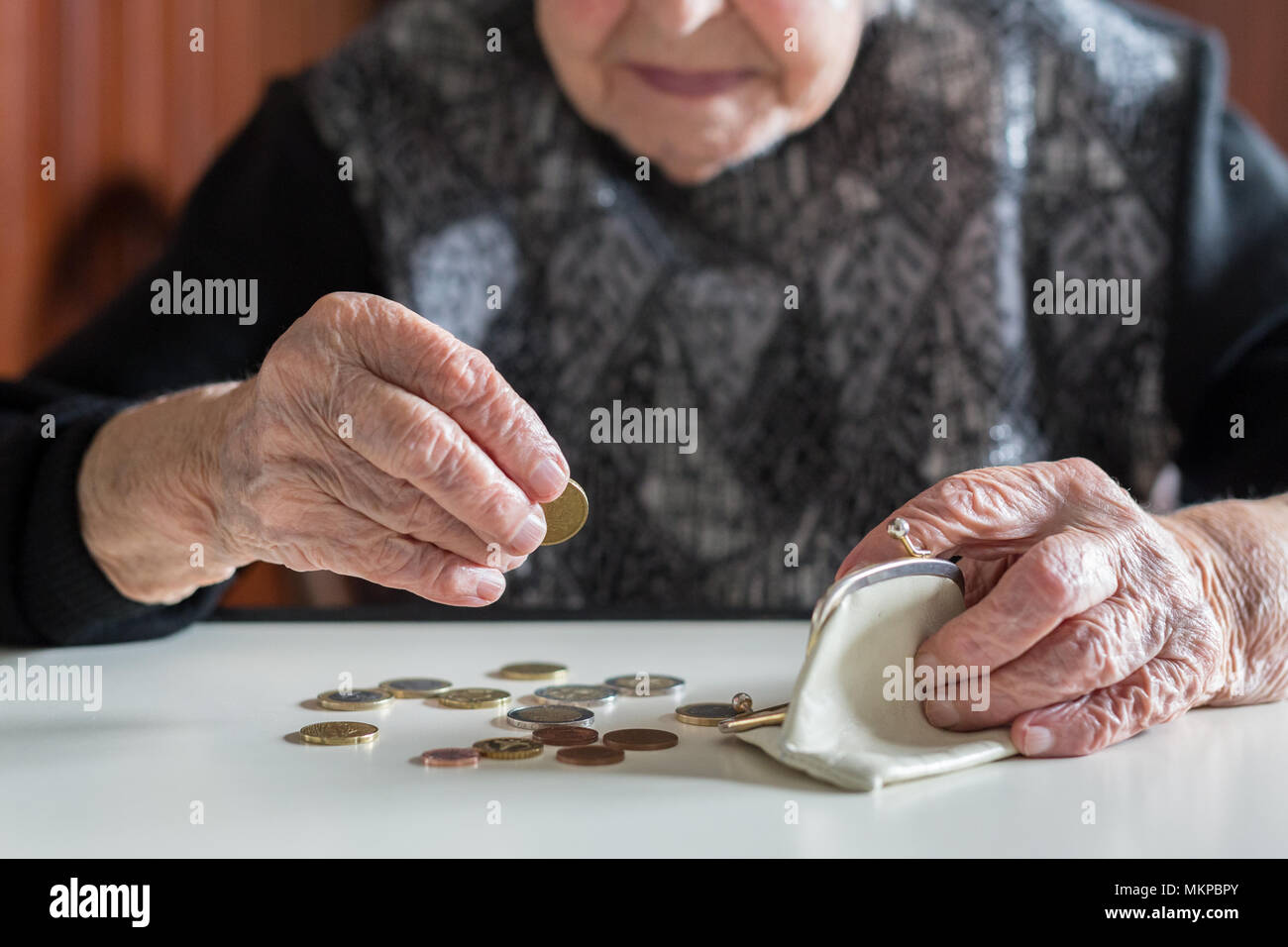 Old person counting coins hi-res stock photography and images - Alamy