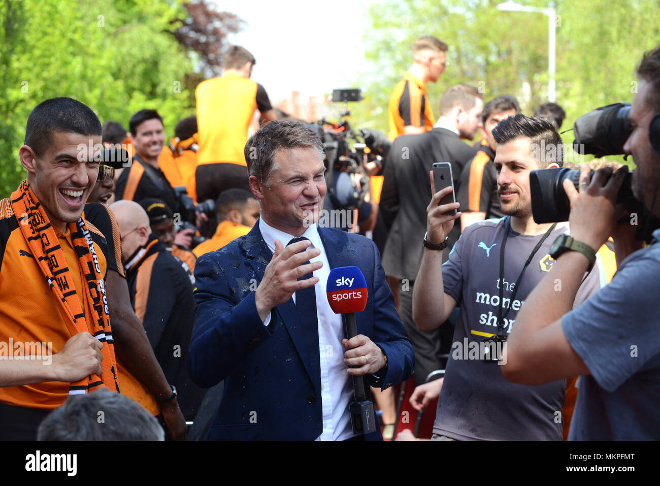 Sky Sports reporter Rob Dorsett gets a soaking from players during ...