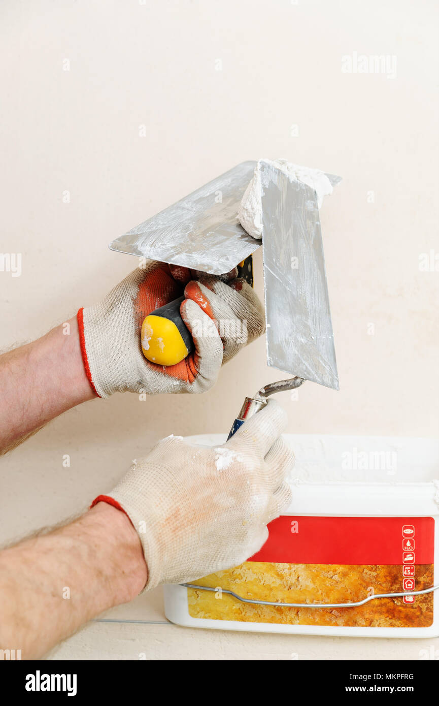Decorative plaster coating. Man takes plaster from container Stock ...