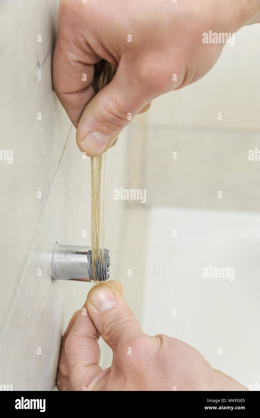 Plumber putting hemp fibers on a thread pipe Stock Photo - Alamy