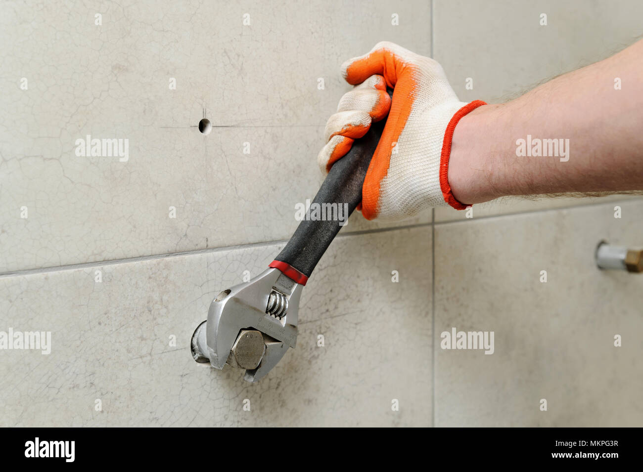 Worker holding adjustable wrench and unscrew the nut Stock Photo - Alamy