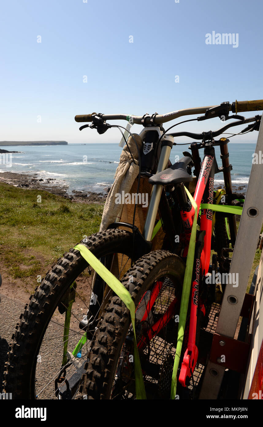 All terrain bikes strapped to vehicle with coast background Stock Photo ...