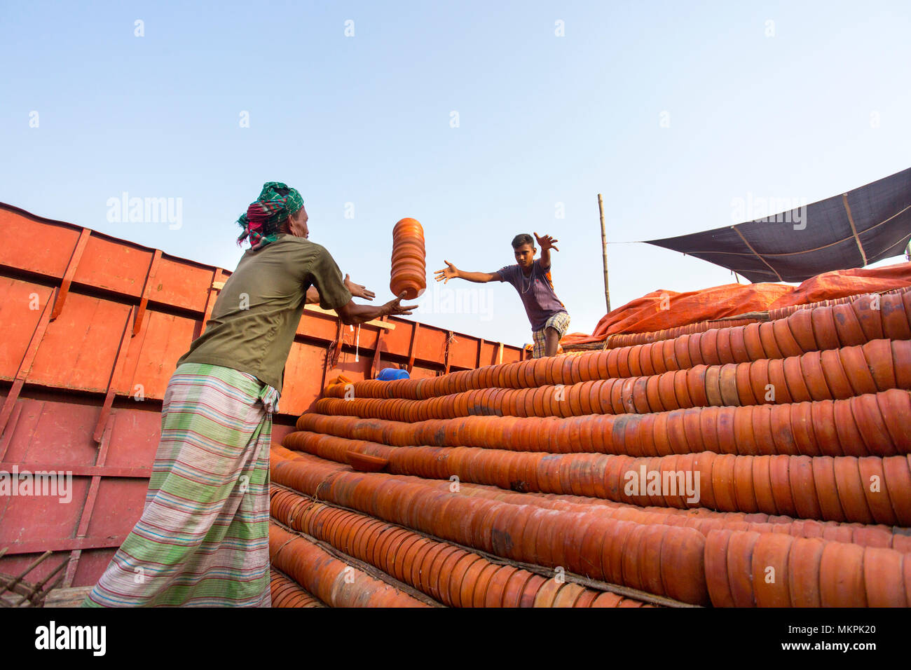Pottery load unload on transporting boat at Burigonga River near ...