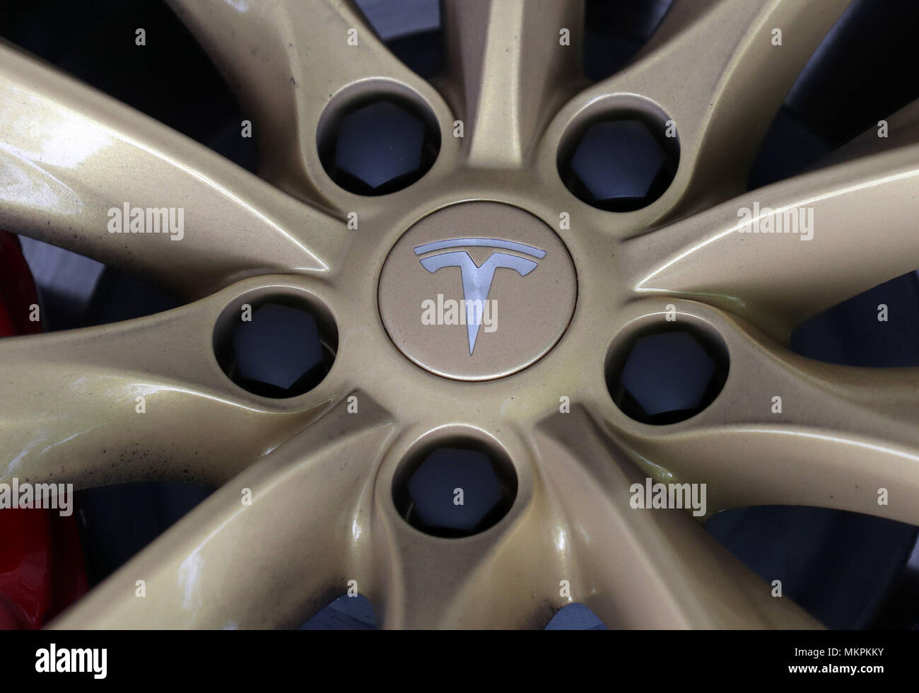 A Tesla logo on the wheel of a Tesla Model S car at a launch event for ...