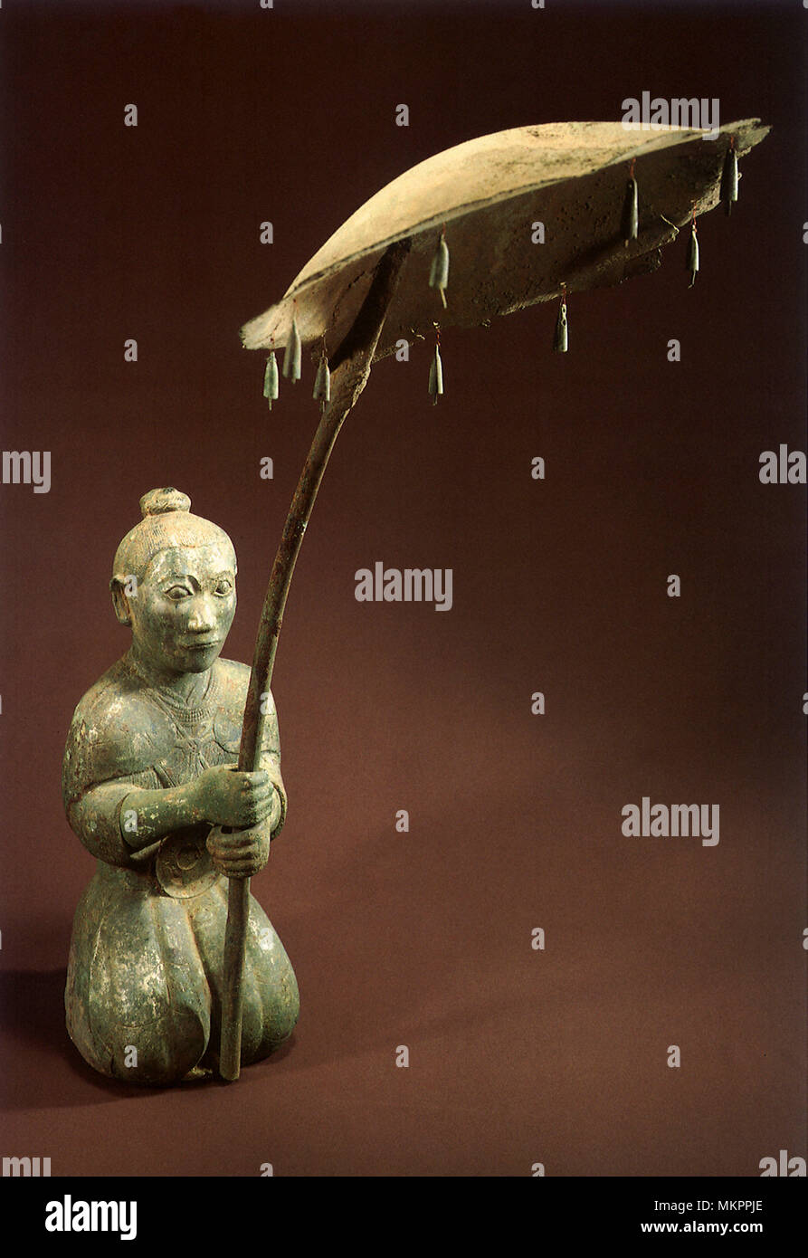Statuette of a Man holding a Parasol Stock Photo - Alamy