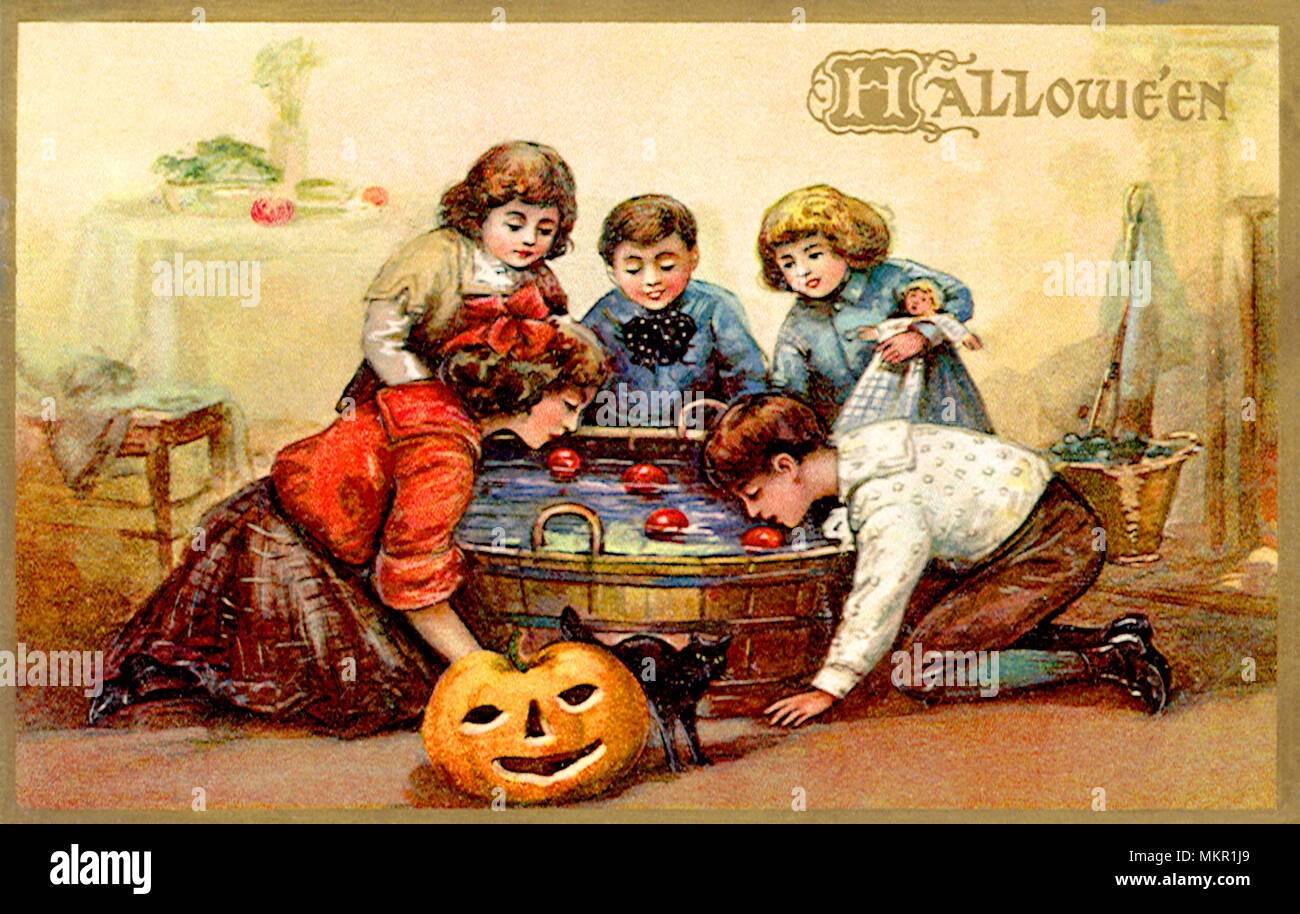 Children bobbing for apples in a barrel Stock Photo - Alamy