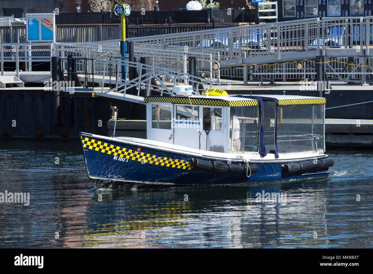 A water taxi makes it's way through the harbor in Boston, Massachusetts ...