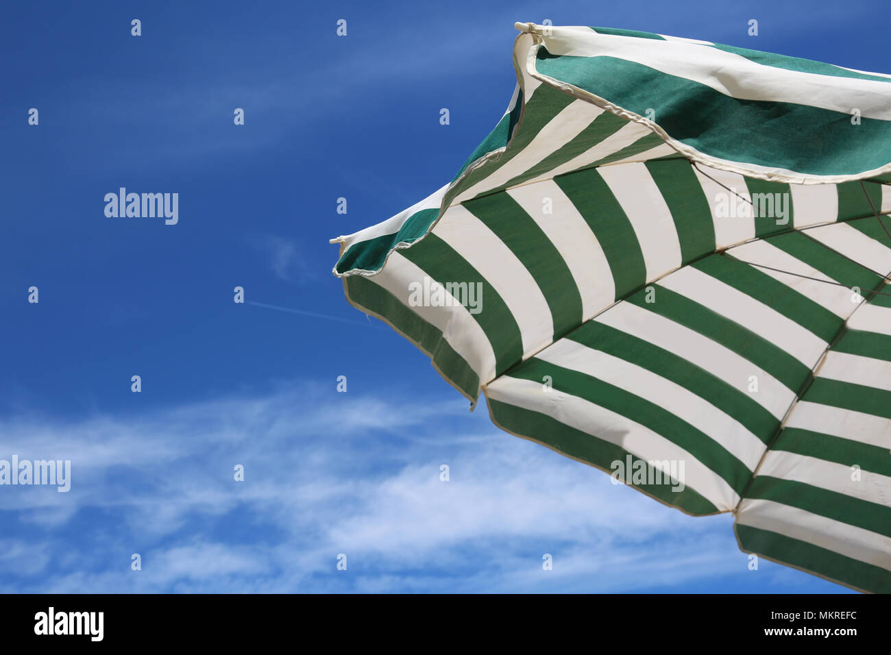 umbrella parasol with blue sky to use like a copy space Stock Photo - Alamy