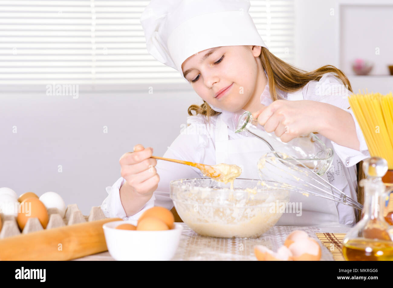 Cute girl cooking in the kitchen at home Stock Photo - Alamy