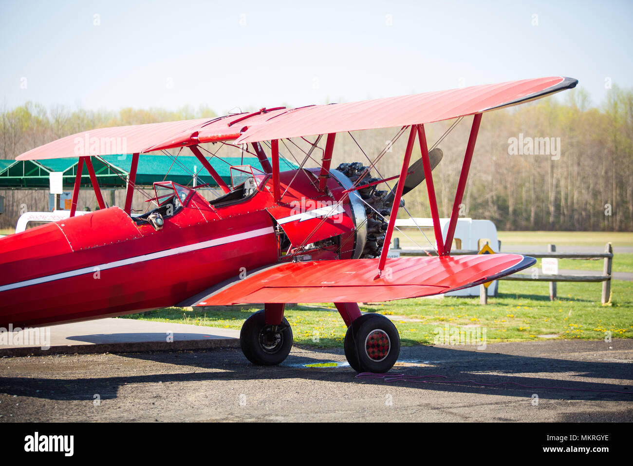 Vintage red plane ready to fly on the field at day Stock Photo - Alamy