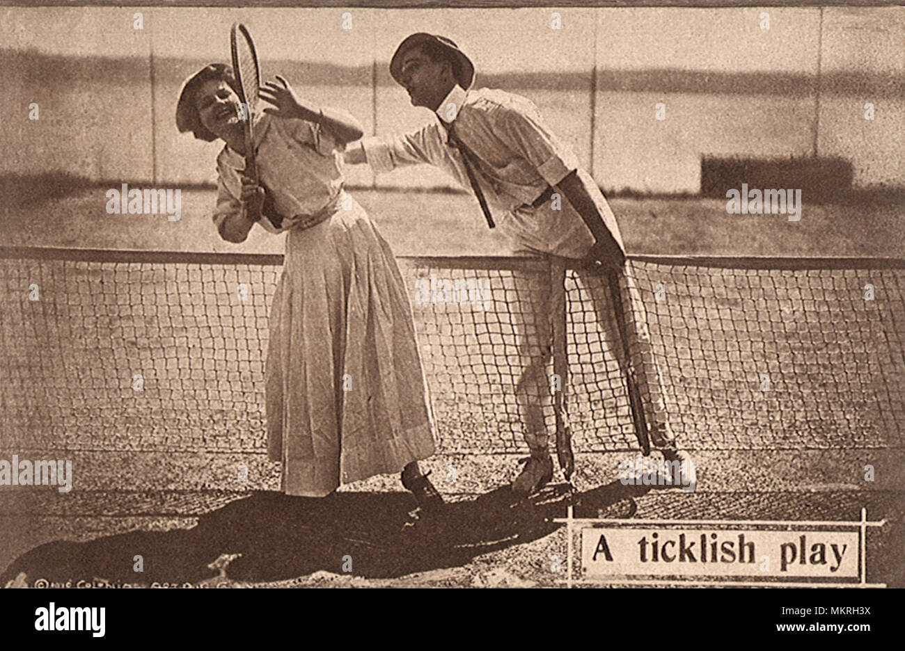 Tennis Couple having fun at the net Stock Photo - Alamy