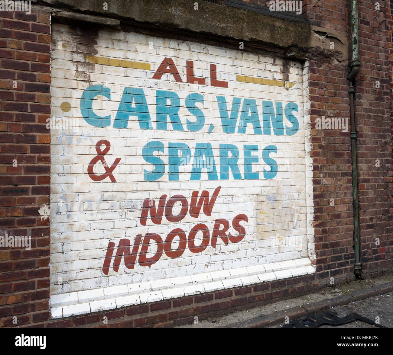 An old urban scrap merchant hand painted sign advertising vehicles and ...