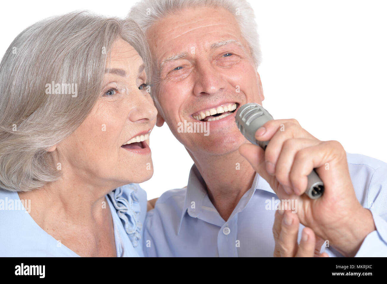 senior couple singing karaoke isolated on white background Stock Photo ...