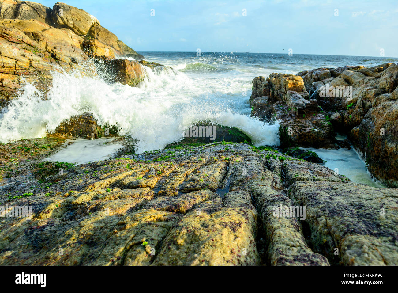 Waves washing against rocks, Kerala india Stock Photo - Alamy