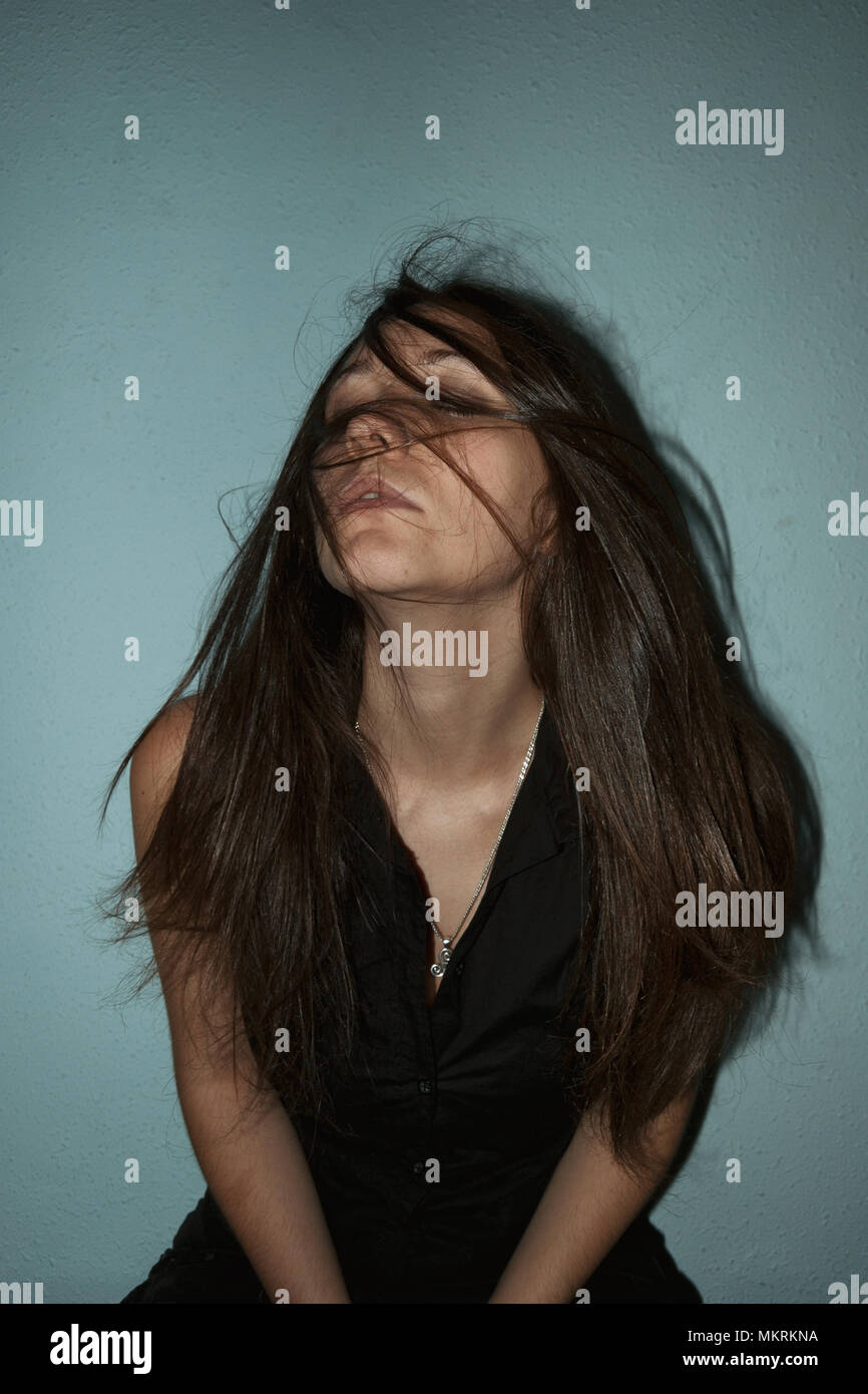 thoughtful girl with closed eyes and hair on her face Stock Photo - Alamy