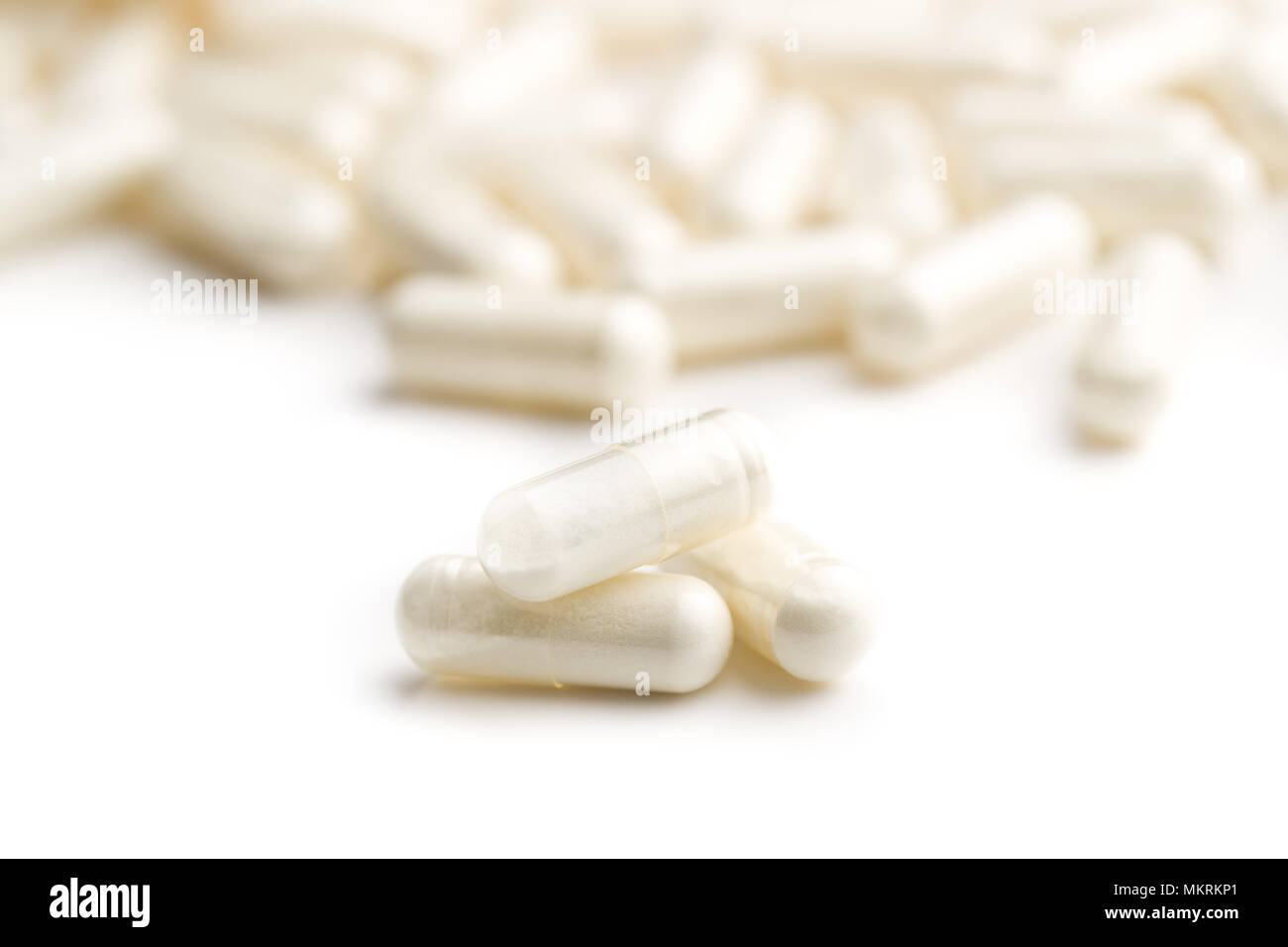 White medicine capsules isolated on white background Stock Photo - Alamy