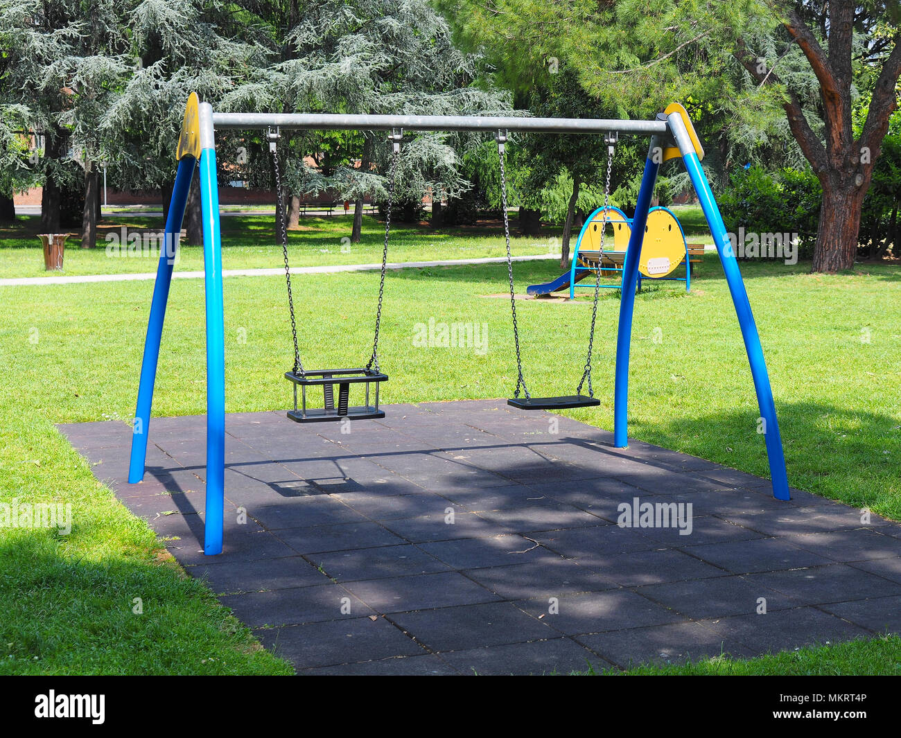 Swings playground in the city park Stock Photo - Alamy