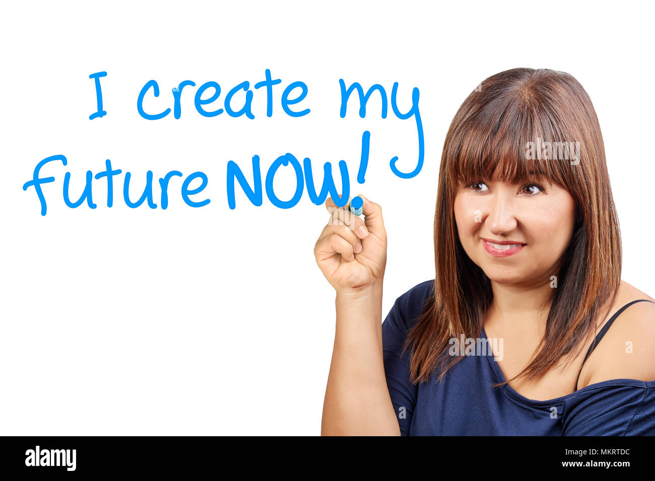 Brunette woman writing I create my future now with felt tip pen ...