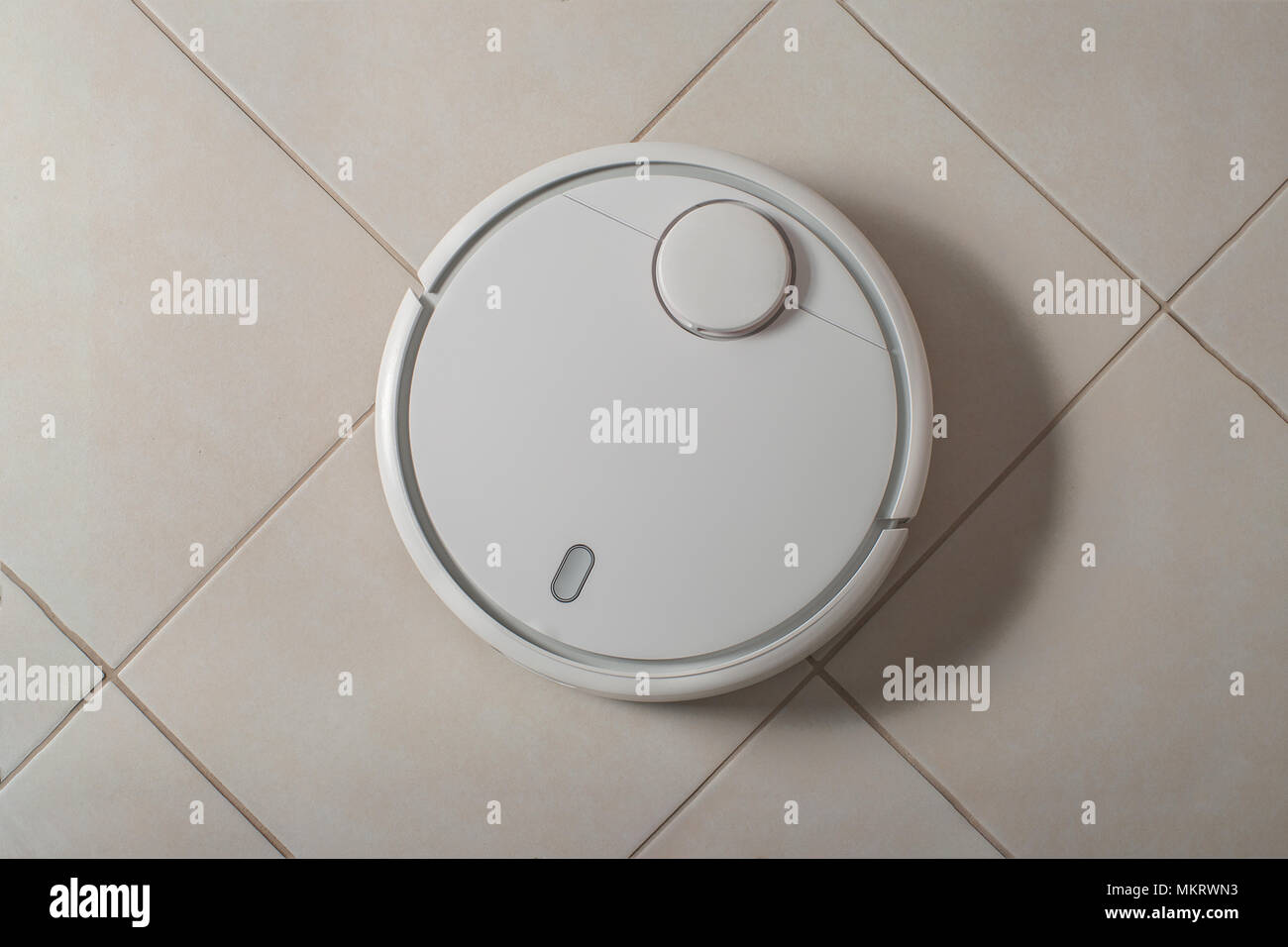 Robot vacuum cleaner with shadow cleaning dust on tile floors. Modern ...