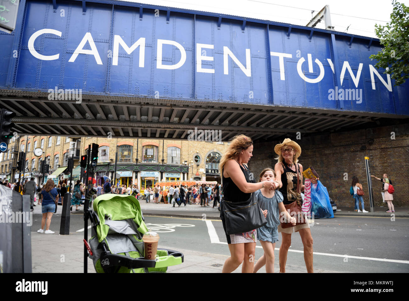 Camden Town railway bridge - people passing by in Camden Town, London ...