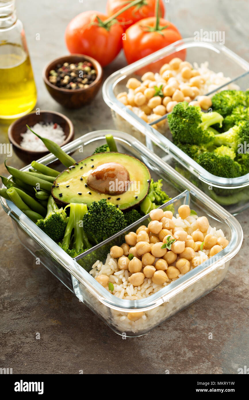 Vegan meal prep containers with cooked rice, chickpeas and vegetables ...