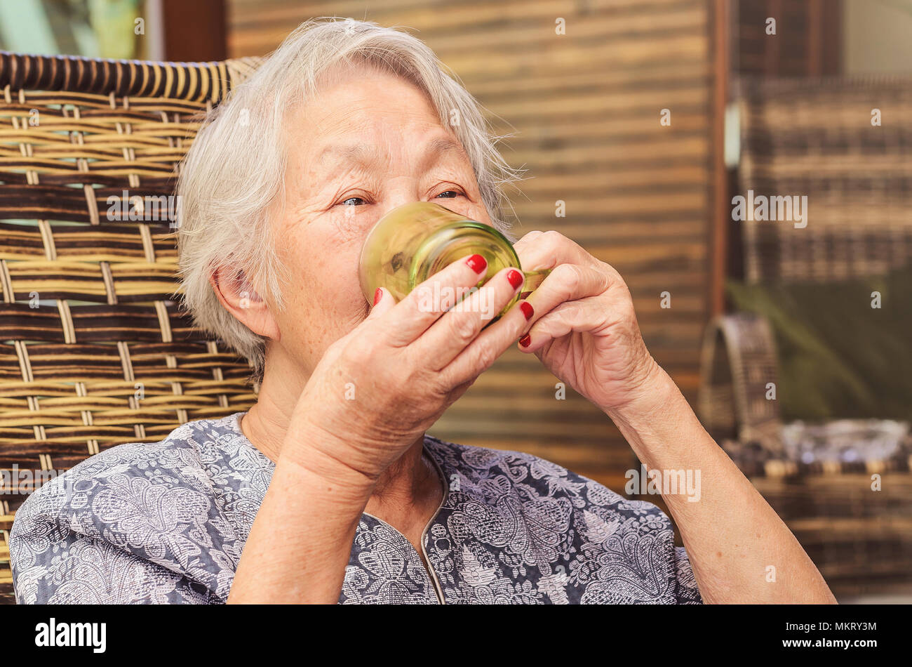 Old lady seated comfortably at home drinking a cup of coffee Stock ...