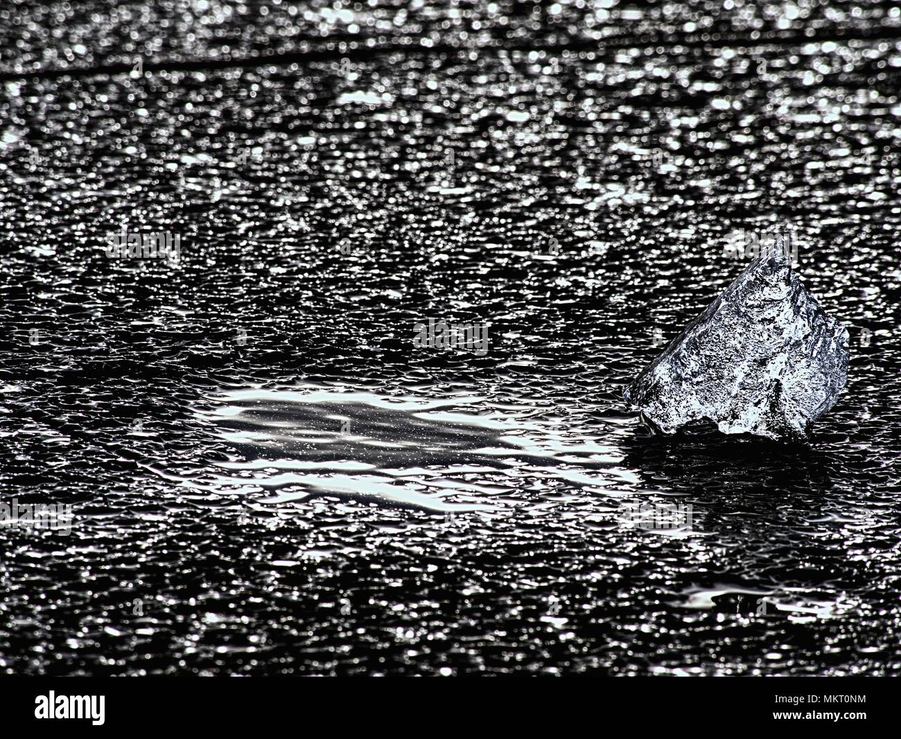 Structured frozen mud. Shore of frozen puddle against to the sunlight ...
